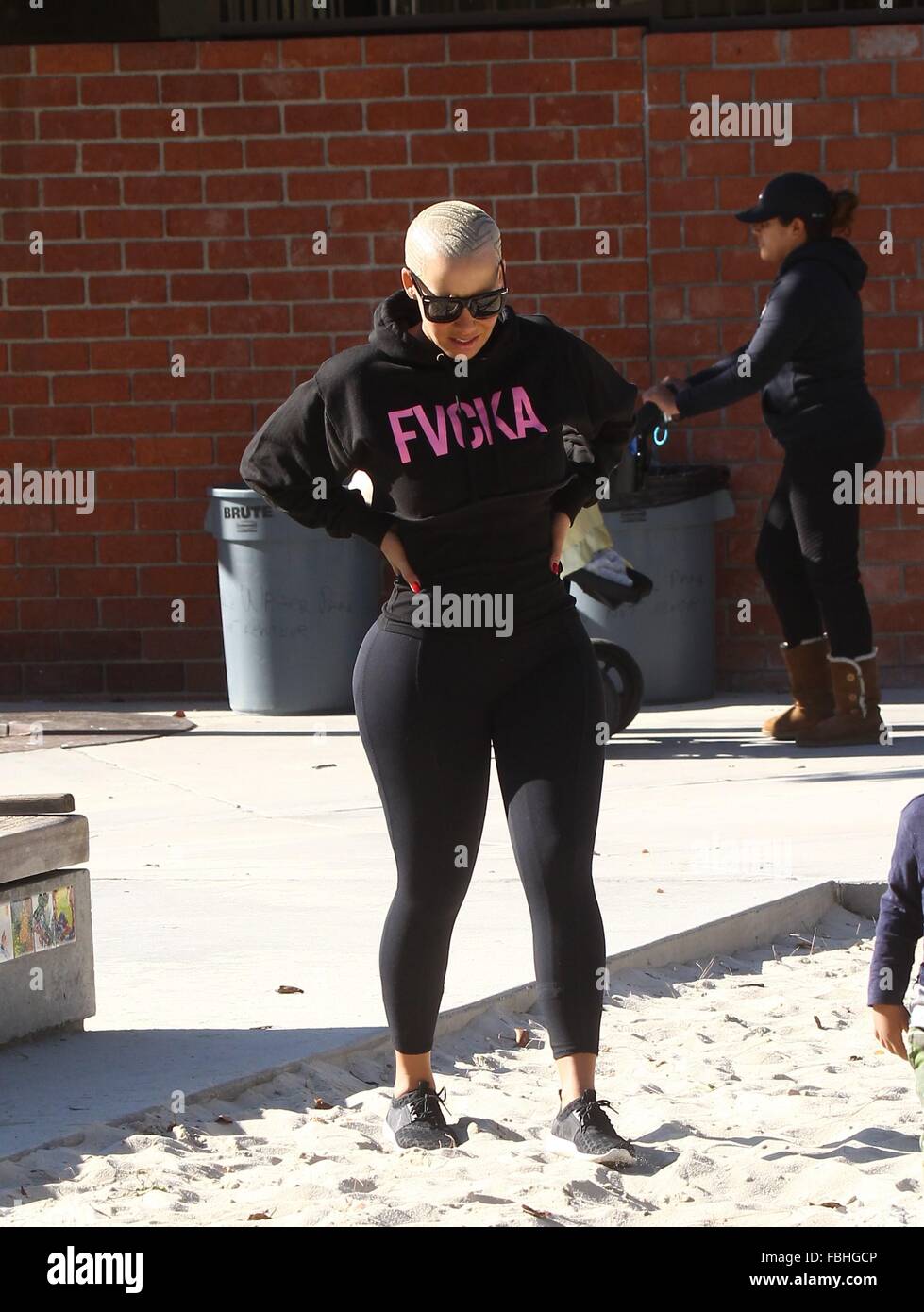 Amber Rose dressed in a FVCKA jogging suit, takes her son to the park ...
