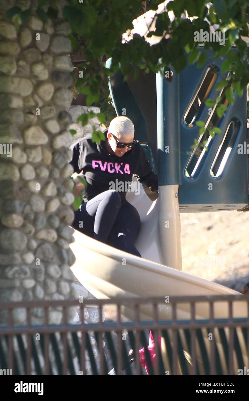Amber Rose dressed in a FVCKA jogging suit, takes her son to the park ...