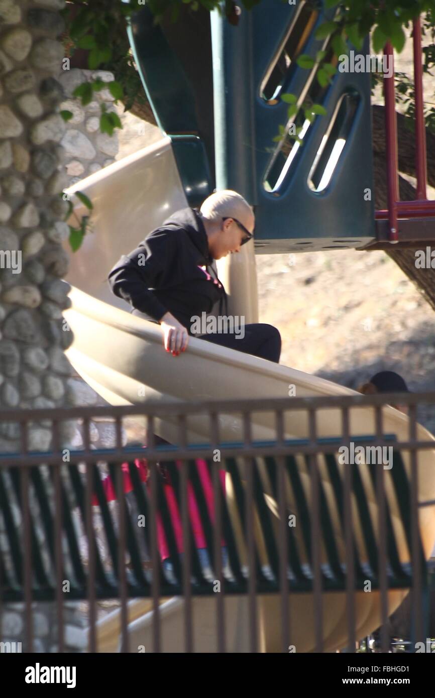 Amber Rose dressed in a FVCKA jogging suit, takes her son to the park ...