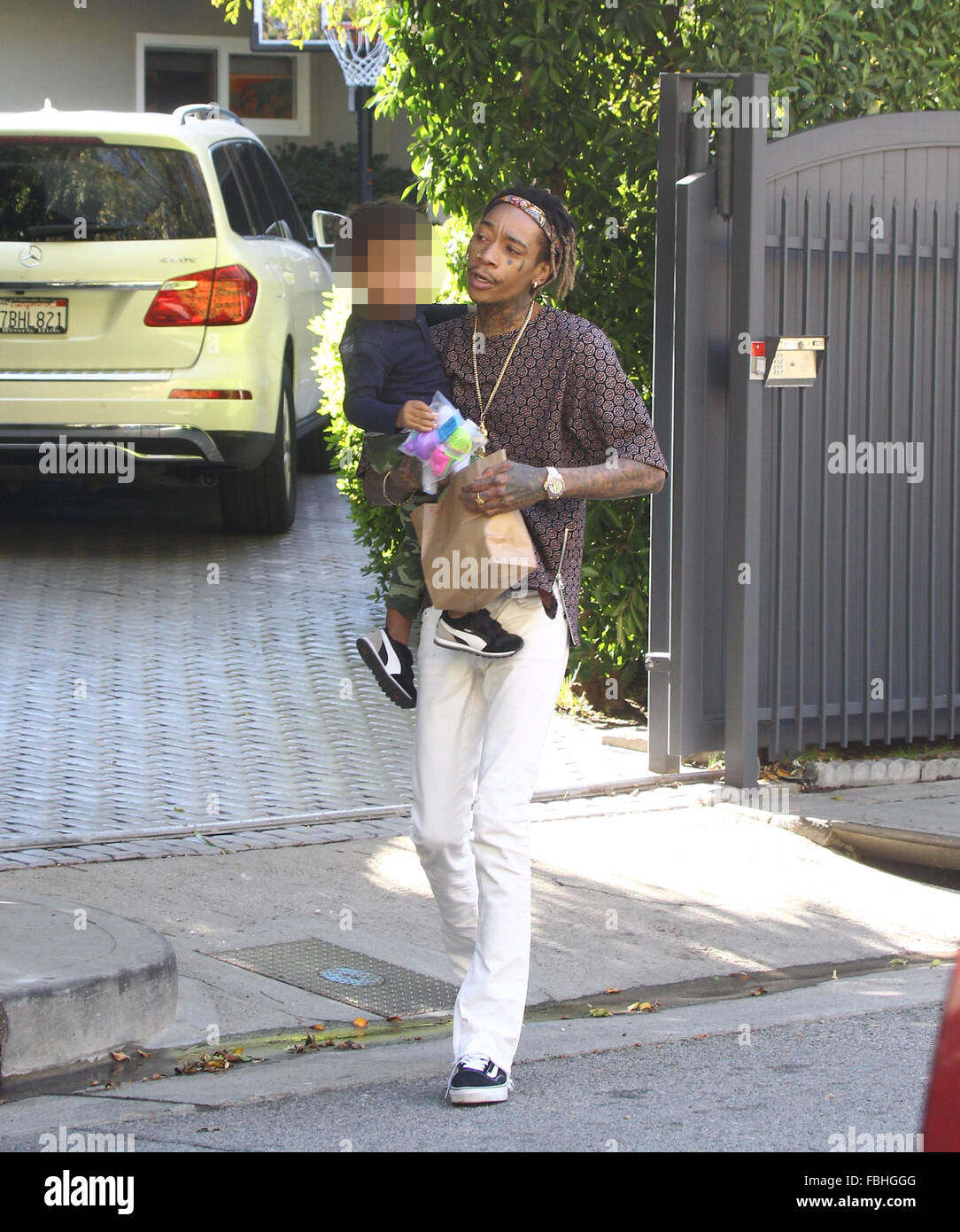 Amber Rose dressed in a FVCKA jogging suit, takes her son to the park ...