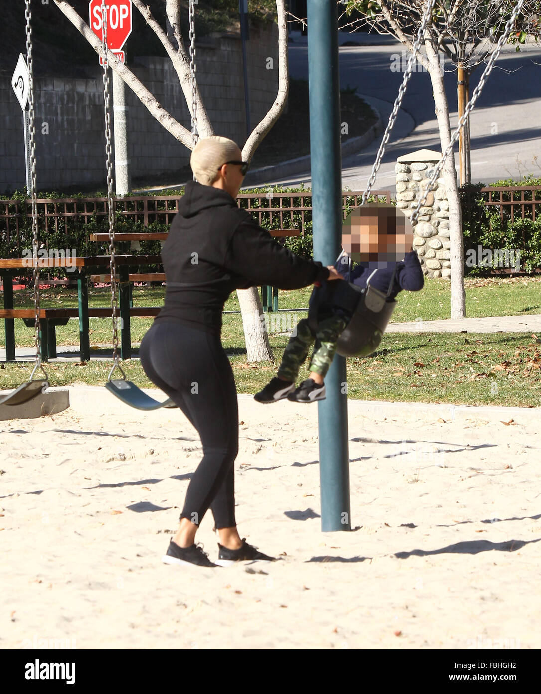 Amber Rose dressed in a FVCKA jogging suit, takes her son to the park ...