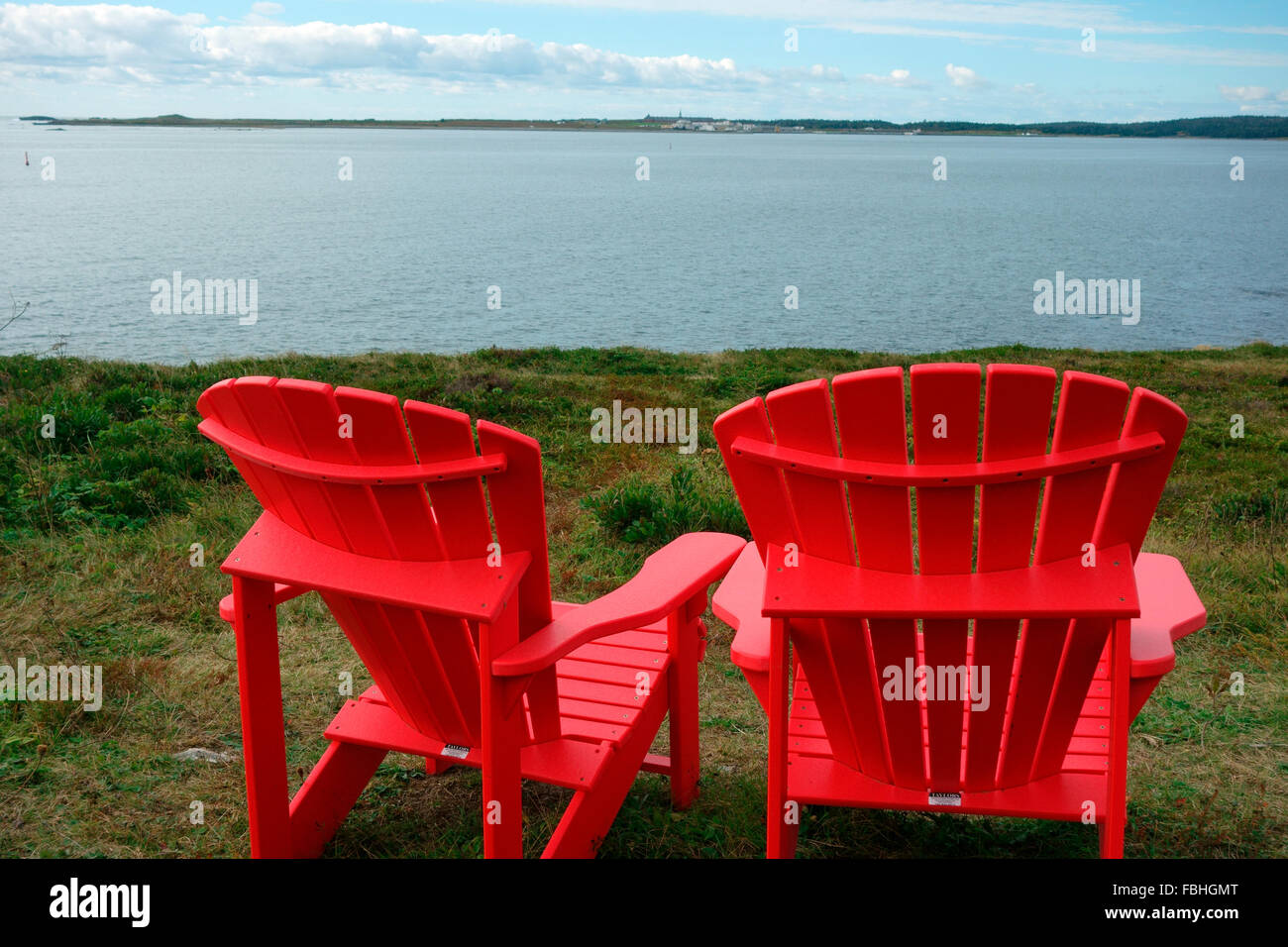 Red Adirondack chairs overlooking Louisbourg Harbour and the Fortress ...