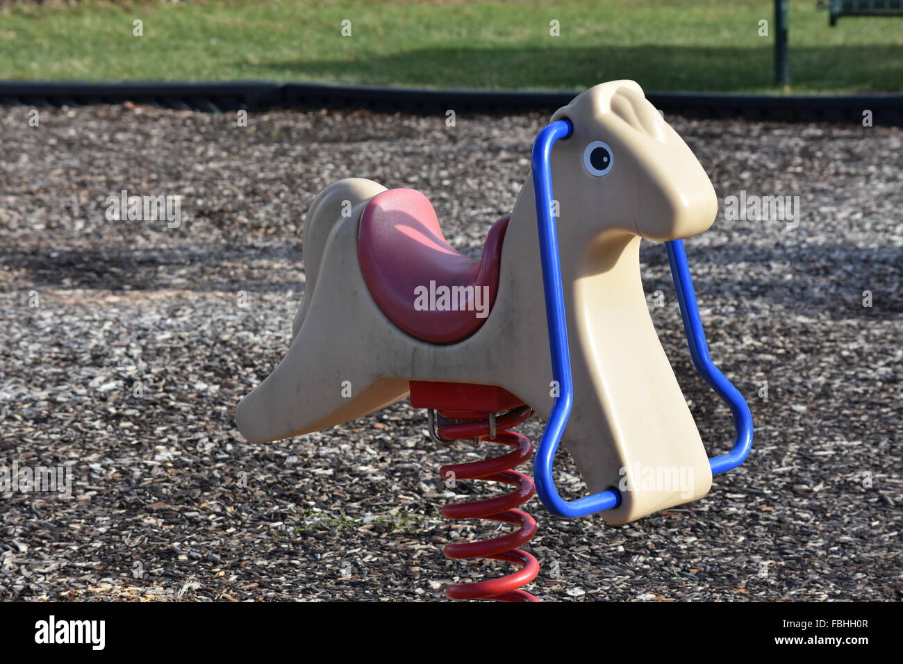 A fun spring animal for kids at a wood chip covered playground Stock ...
