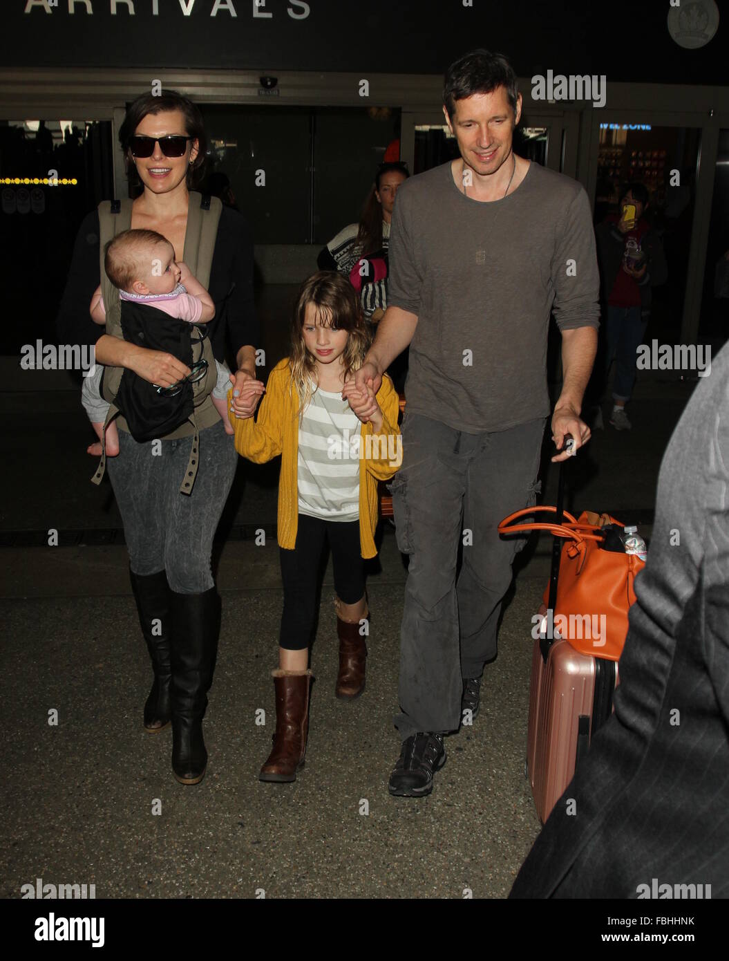 Milla Jovovich and family arrive on a flight to Los Angeles ...