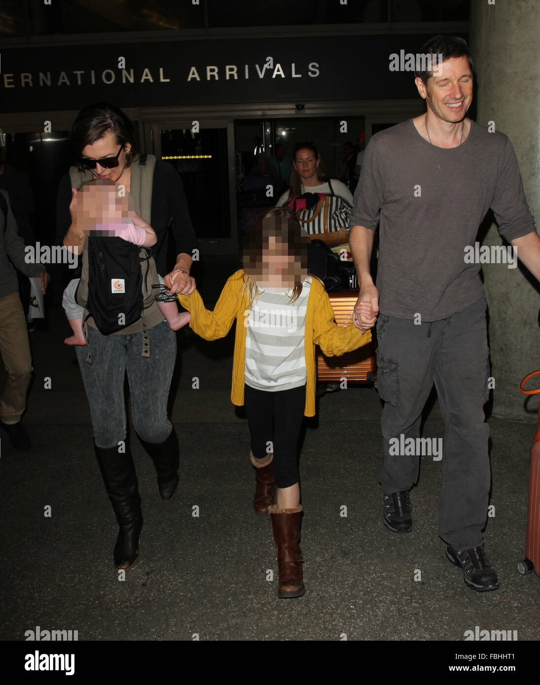 Milla Jovovich and family arrive on a flight to Los Angeles ...
