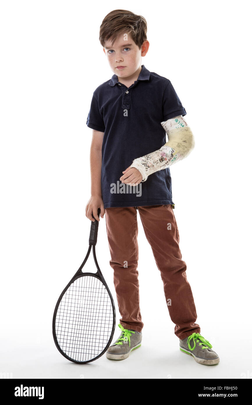 Shot of a cute young boy who has broken his left arm and is unhappy ...