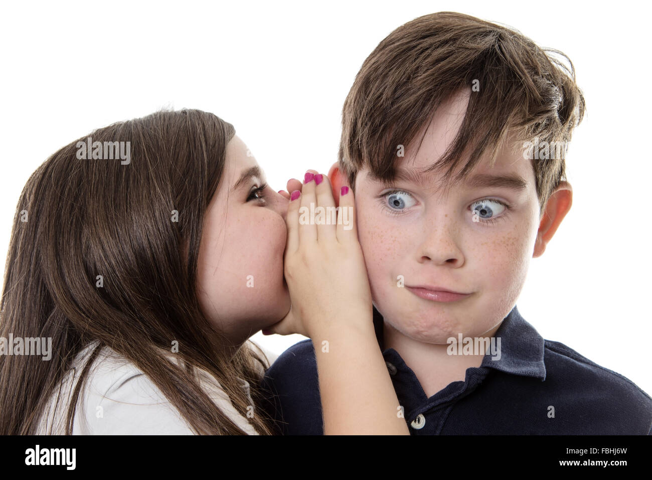 two children whispering into each others ear sharing a secret! Stock ...