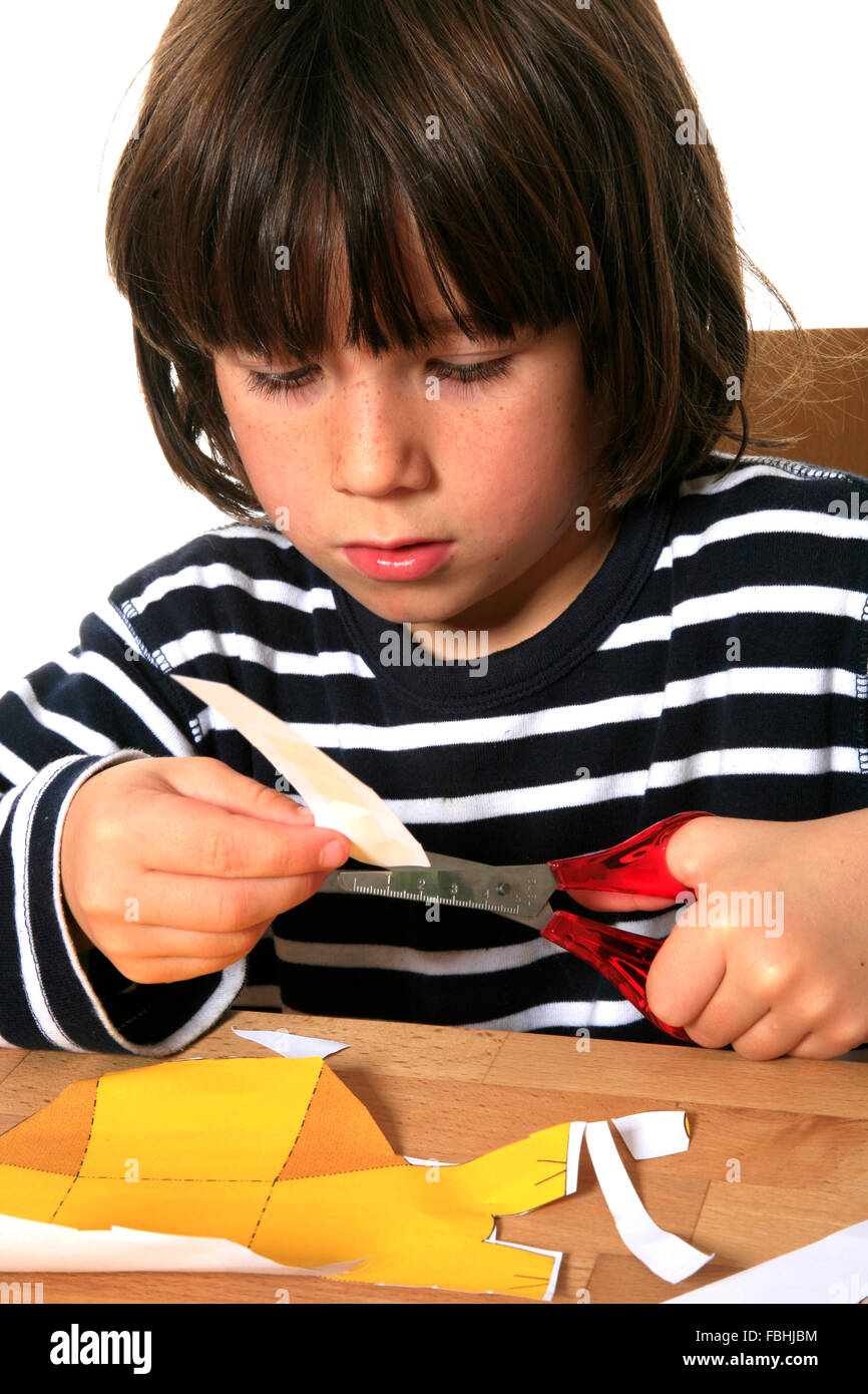 Living room, interior, boy, doing handicraft, cutting Stock Photo - Alamy
