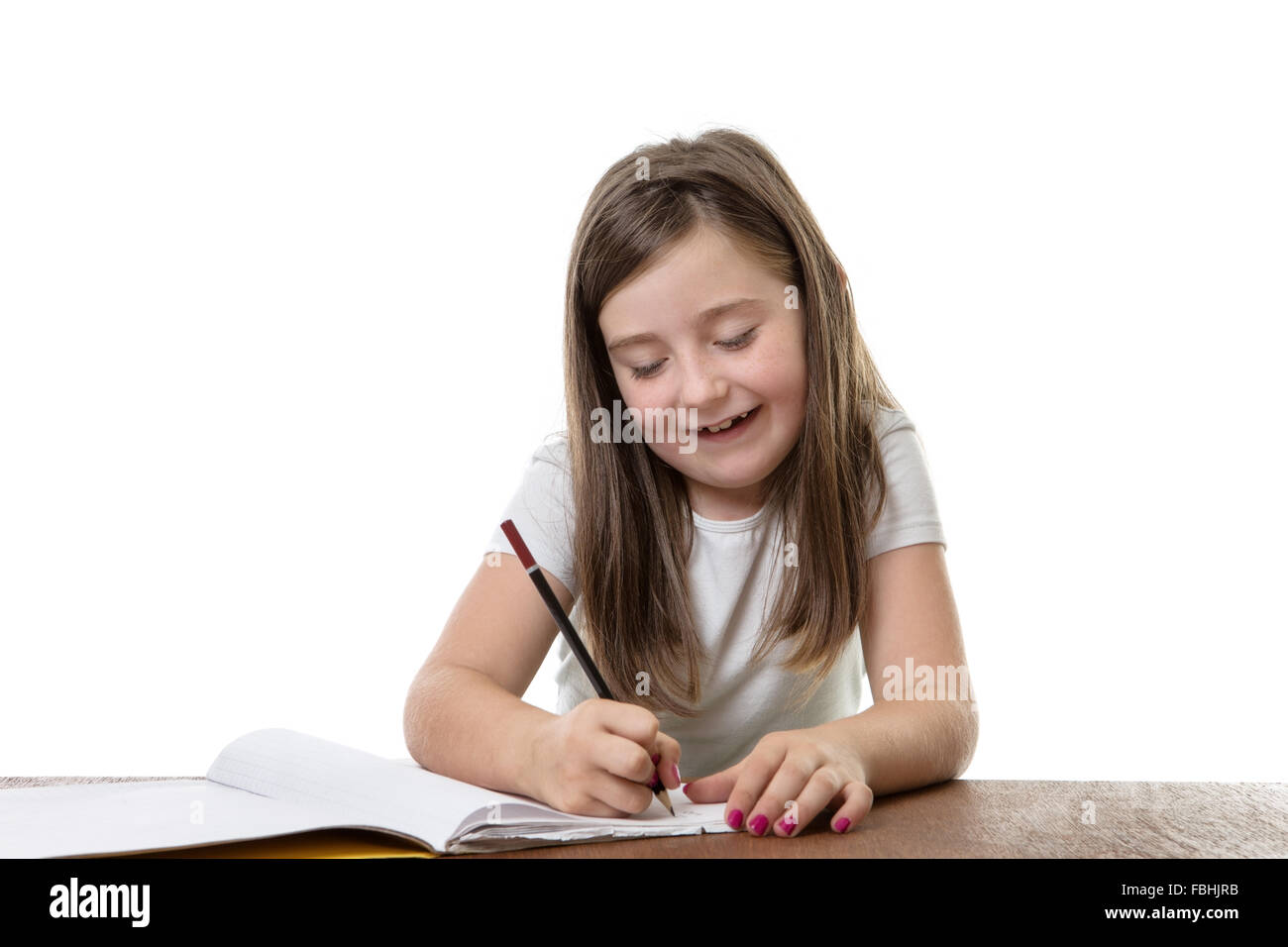 Young girl writing in a book doing her homework Stock Photo - Alamy