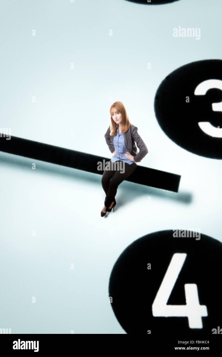 business woman sitting on a clock Stock Photo - Alamy