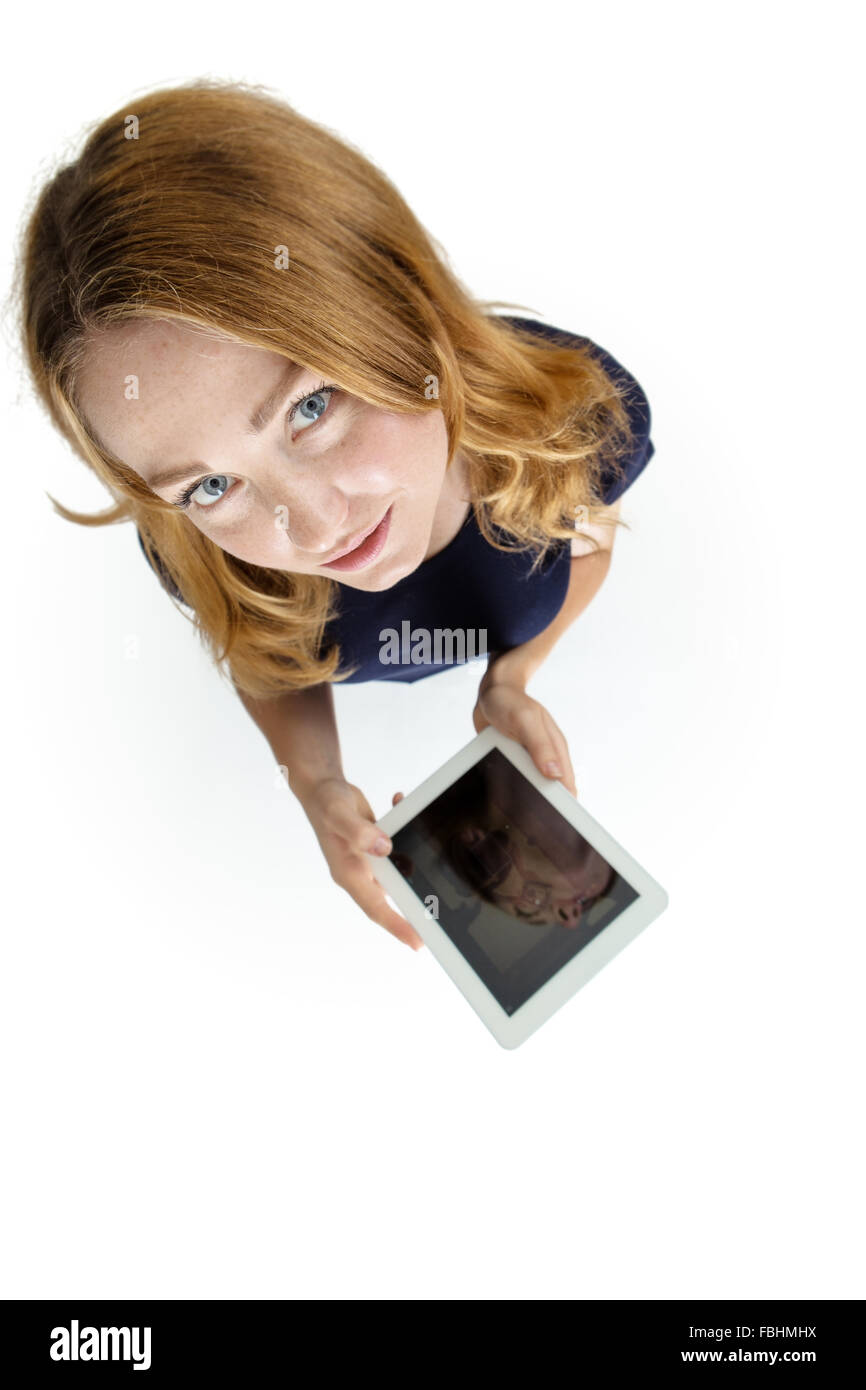Woman standing with her tablet computer infront of her, showing the ...