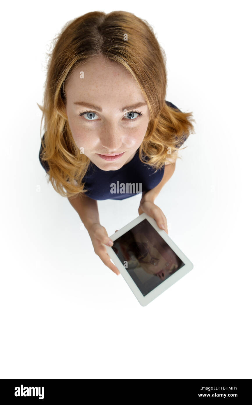 Woman standing with her tablet computer infront of her, showing the ...