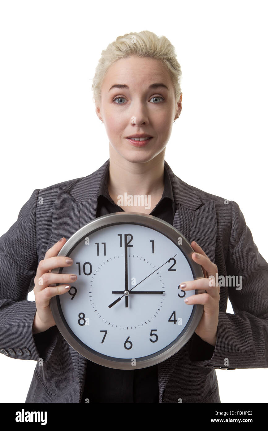 Woman in a suit holding a large clock infront of her with both hands ...