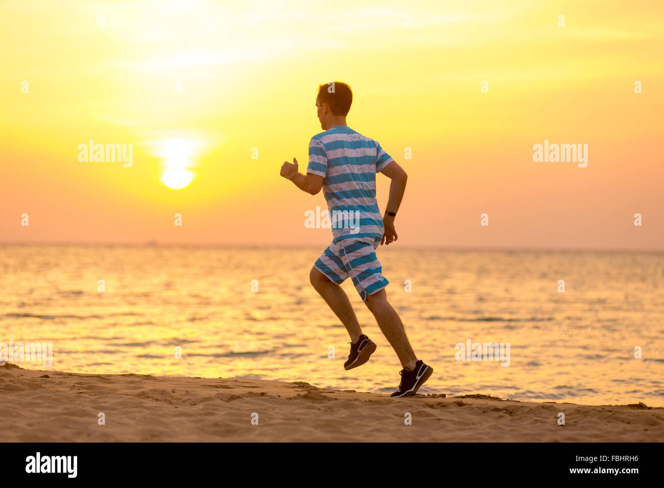 Healthy lifestyle: handsome young man working out outdoor, running fast ...