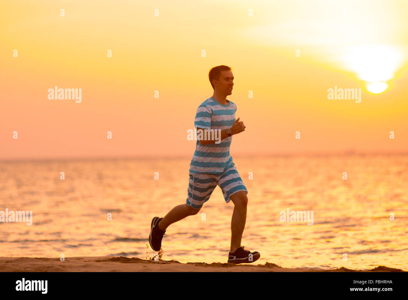 Healthy lifestyle: handsome young man working out outdoor, running fast ...