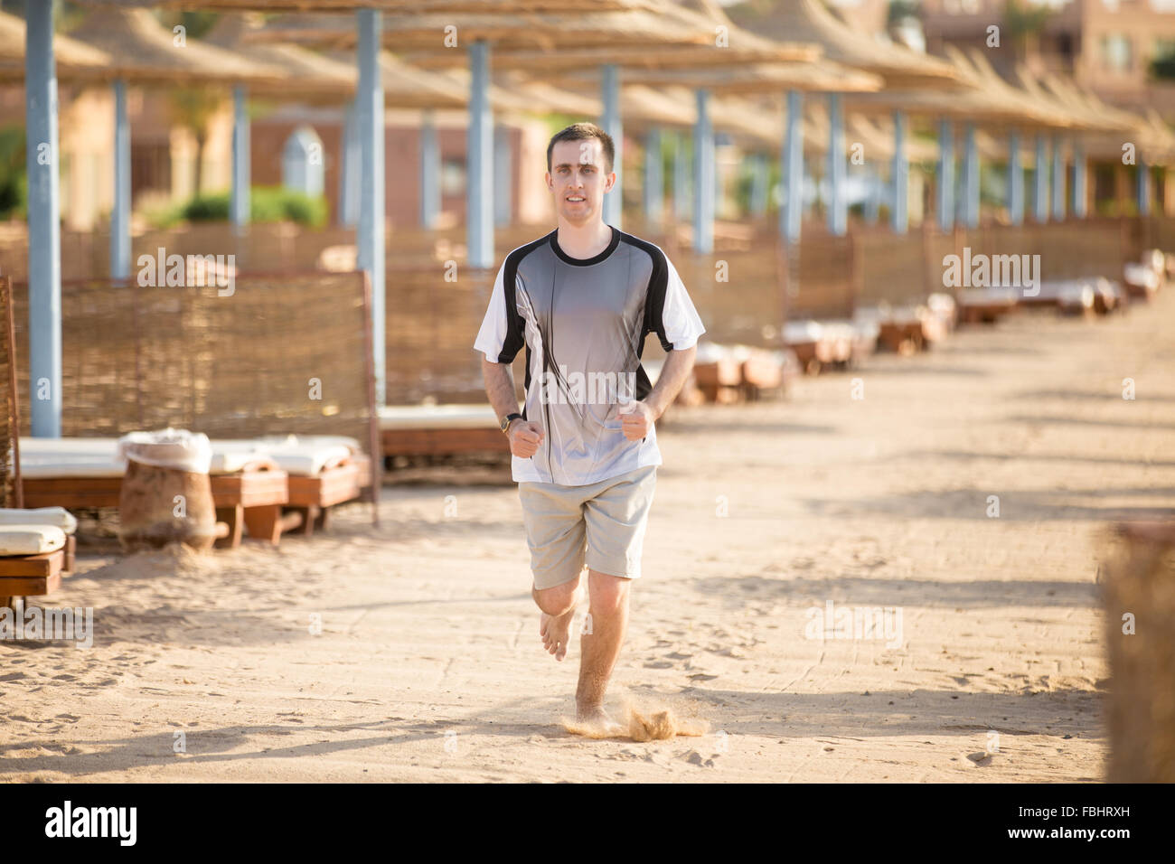 Healthy lifestyle: young sporty man working out outdoors, jogging on ...