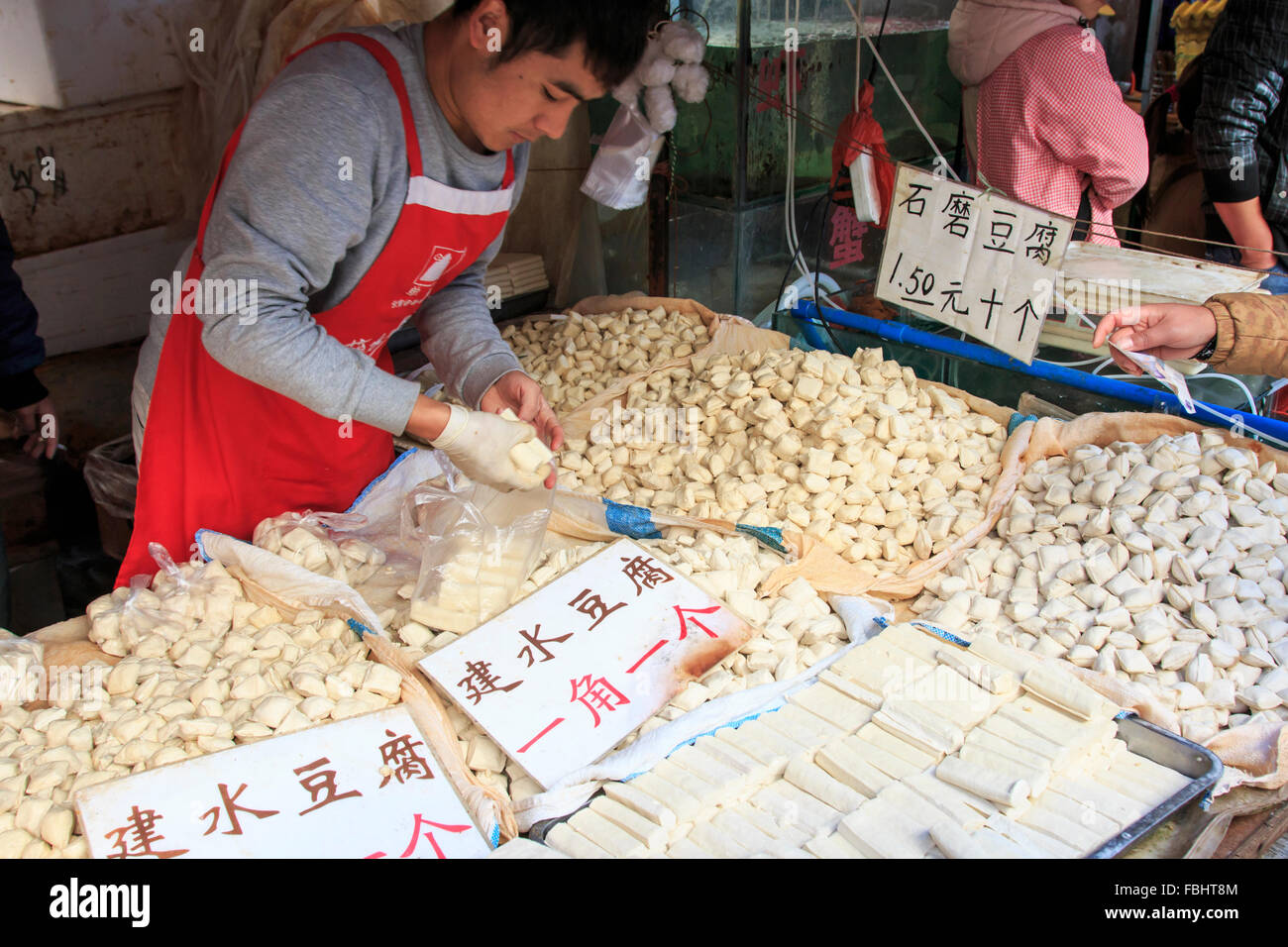 Man selling different varieties of tofu in market in kunming hi-res ...