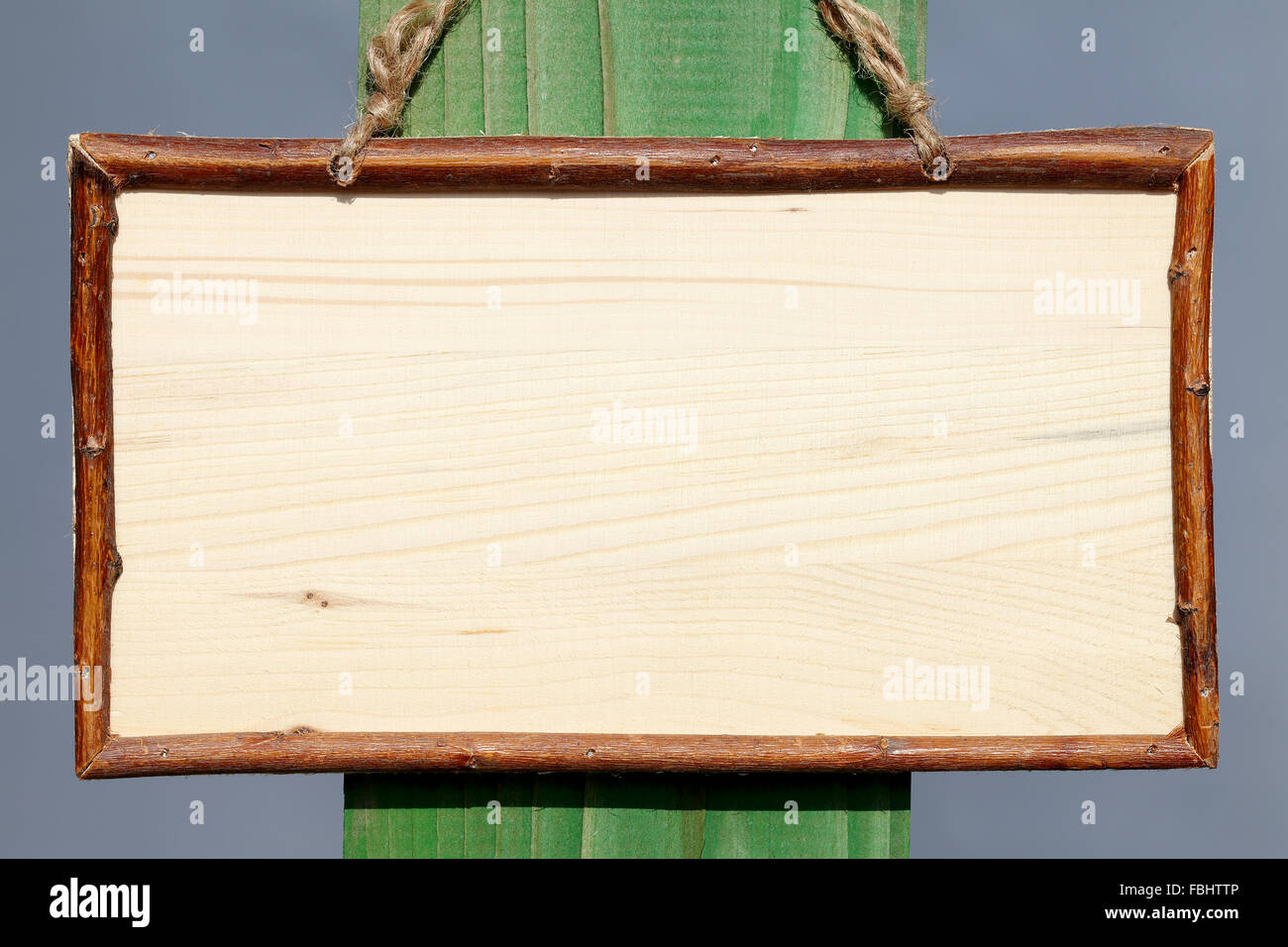 empty wooden sign hanging on a rope Stock Photo - Alamy