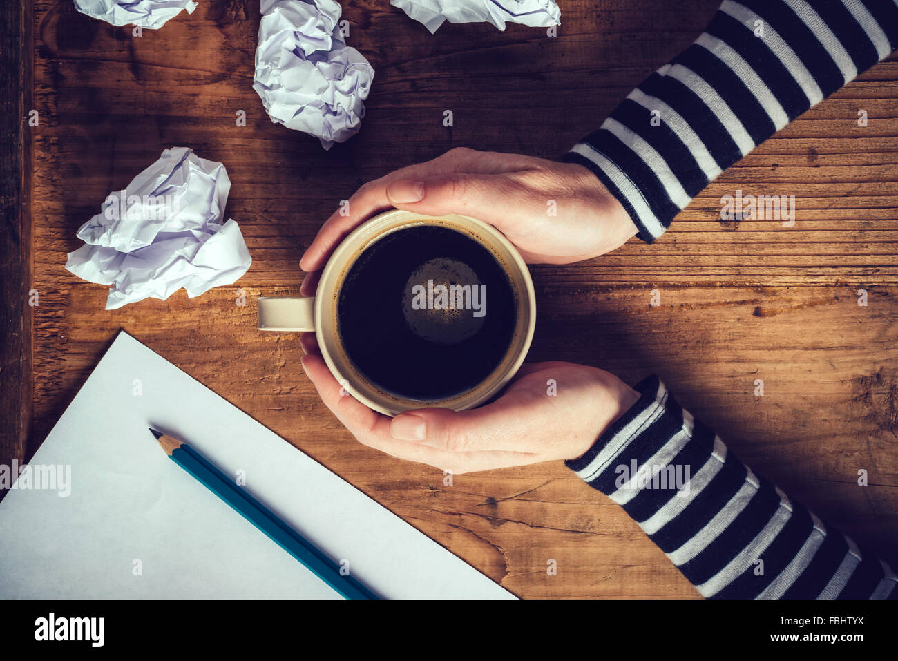 Female writer drinking cup of coffee, top view of female hands holding ...