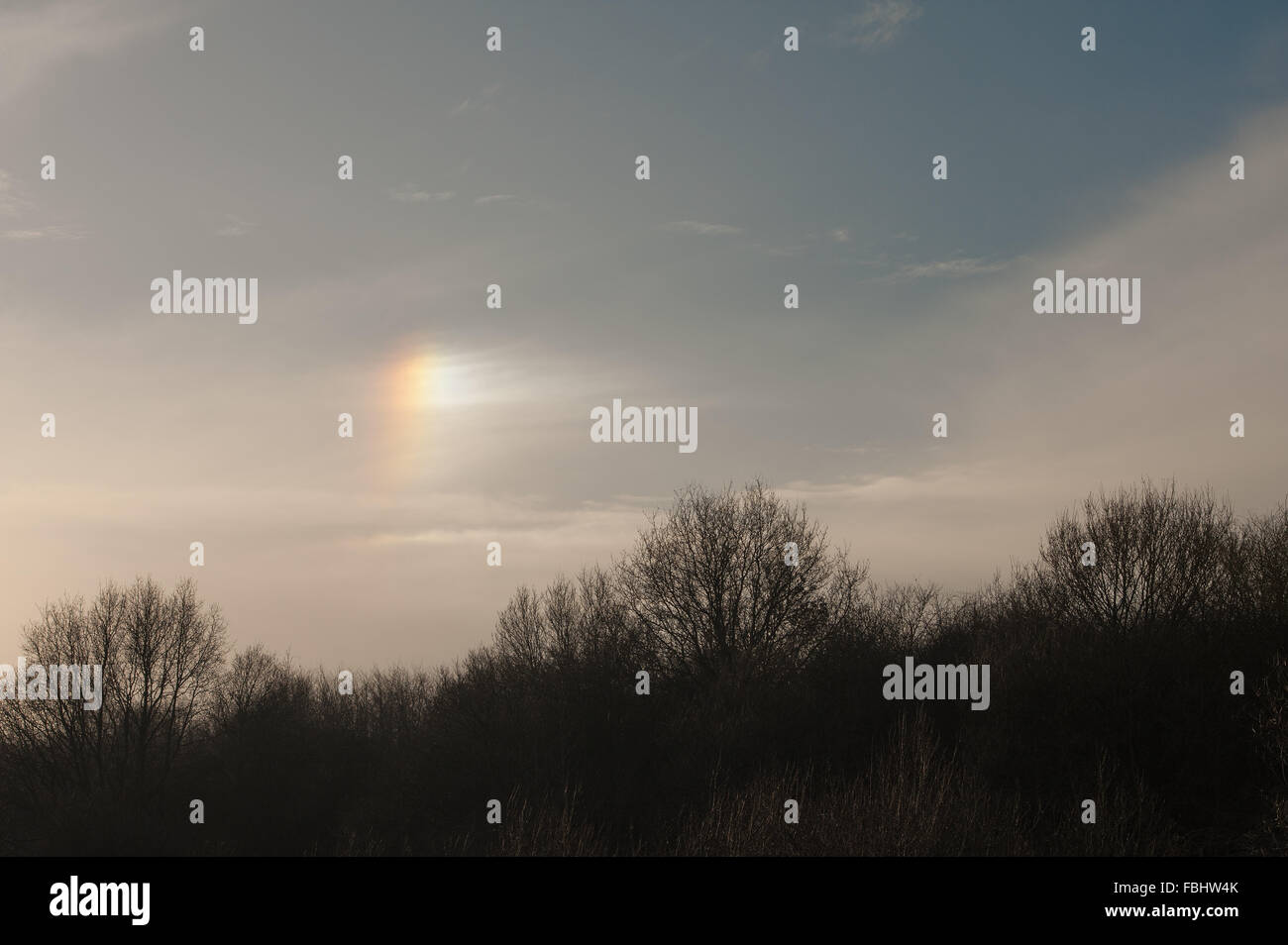ice crystals high in the sky in cirrostratus or cirrus layer as sun dog ...