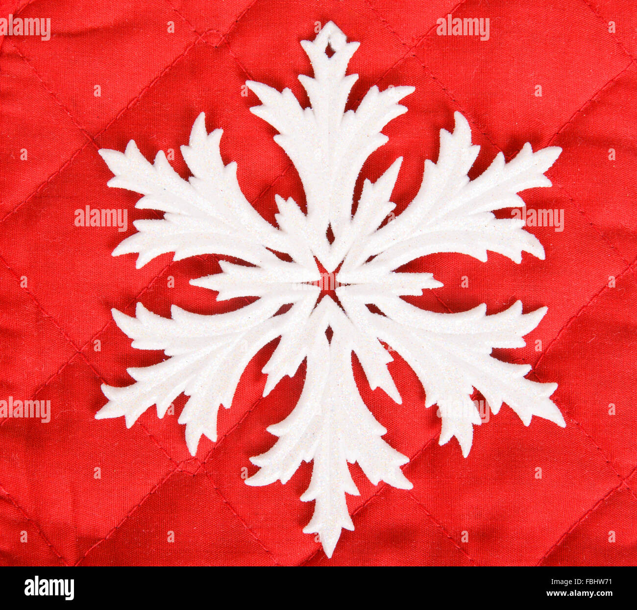 White snowflake isolated on red background Stock Photo - Alamy
