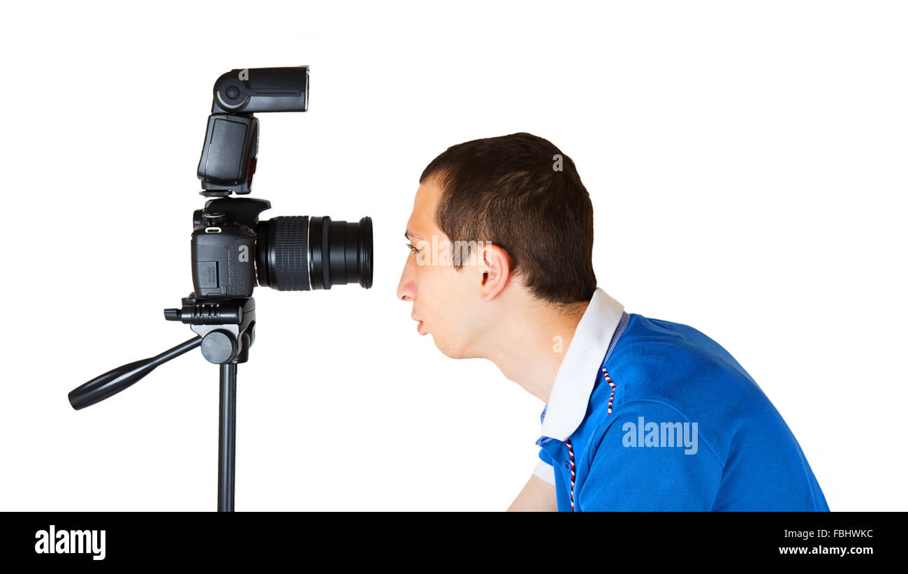 Young man looking into the camera lens on a white background Stock ...