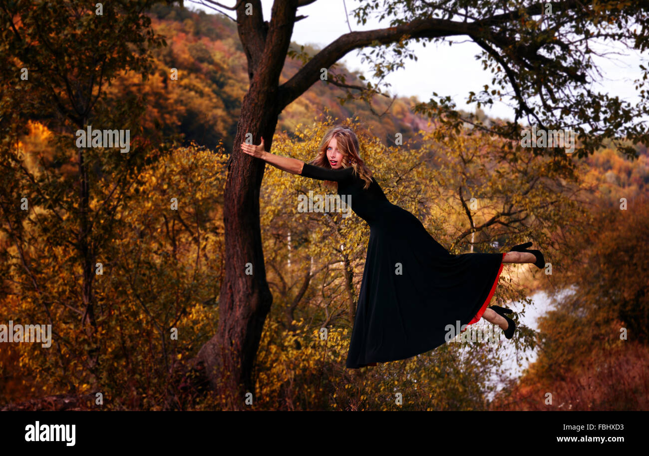 Young woman levitating in the forest Stock Photo - Alamy