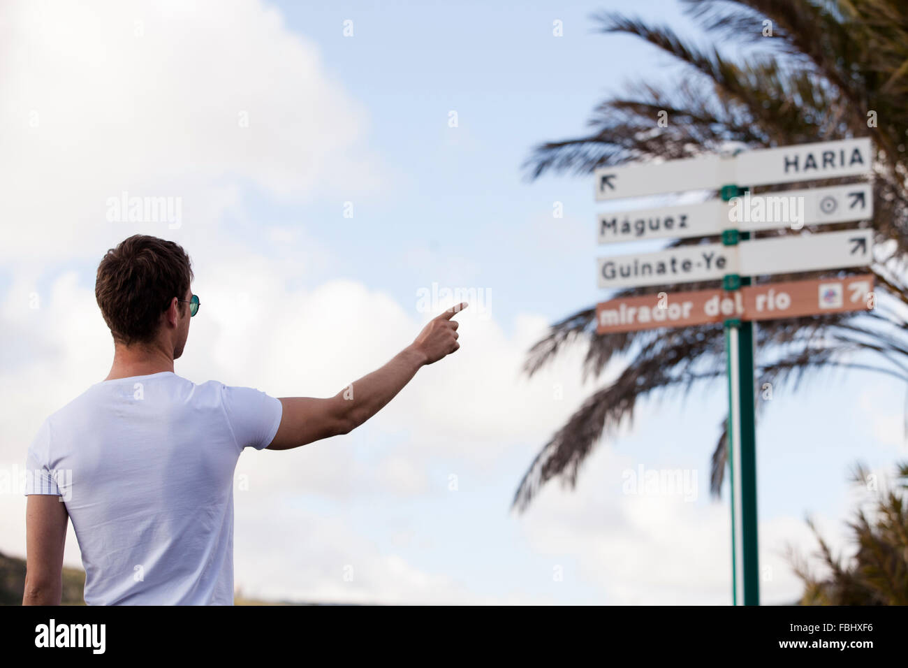 young man pointing at sign Stock Photo - Alamy