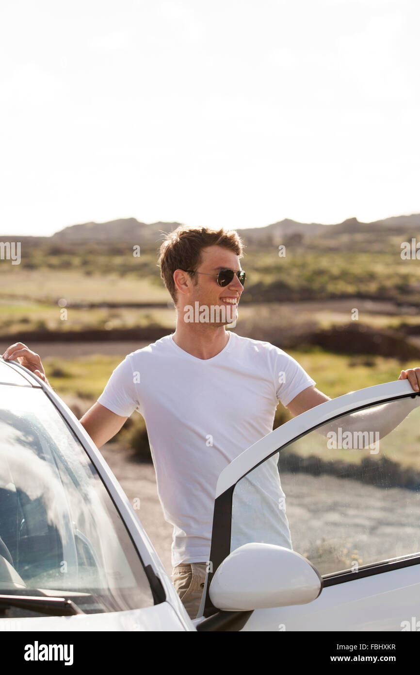 young man getting out of car Stock Photo - Alamy