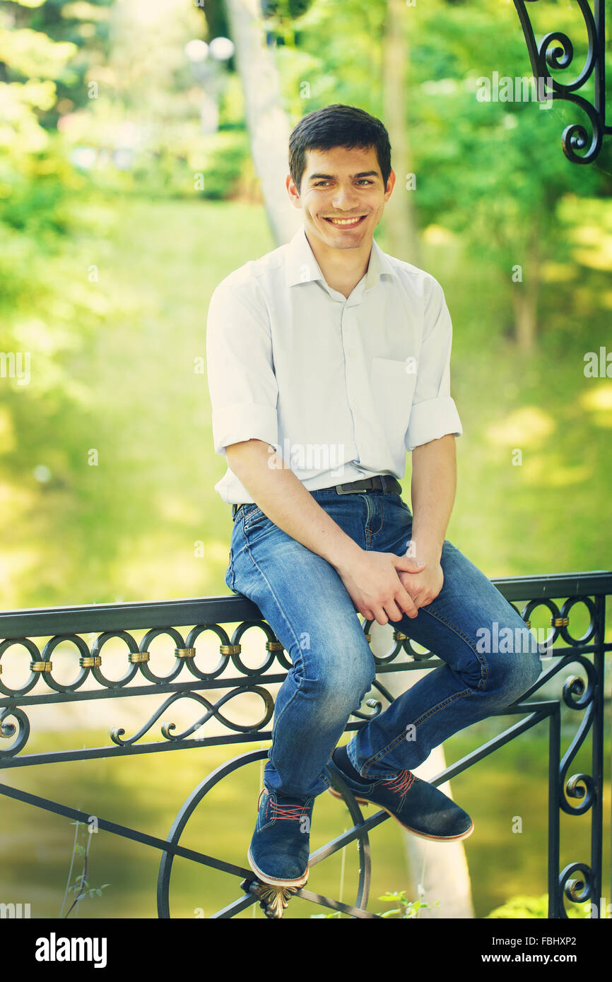 Portrait of a smiling young man on nature Stock Photo - Alamy