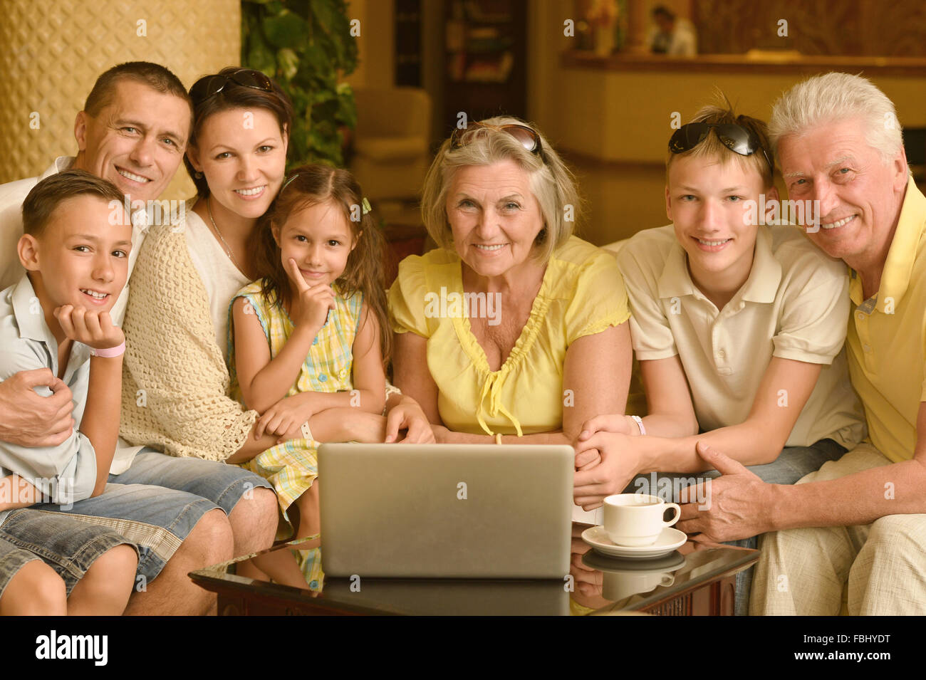 family sitting with laptop Stock Photo - Alamy