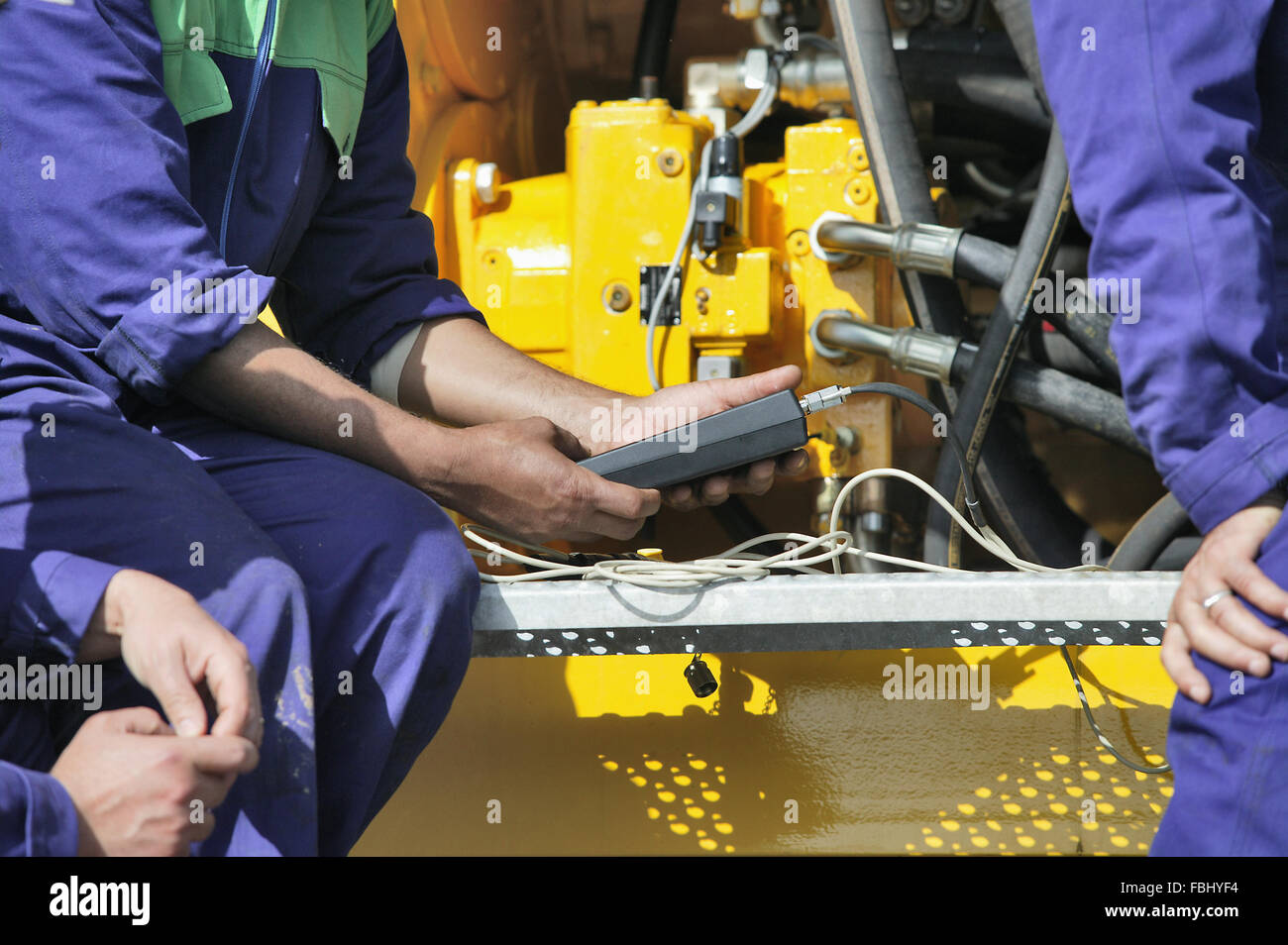 Technician performing periodic engine maintenance Stock Photo - Alamy