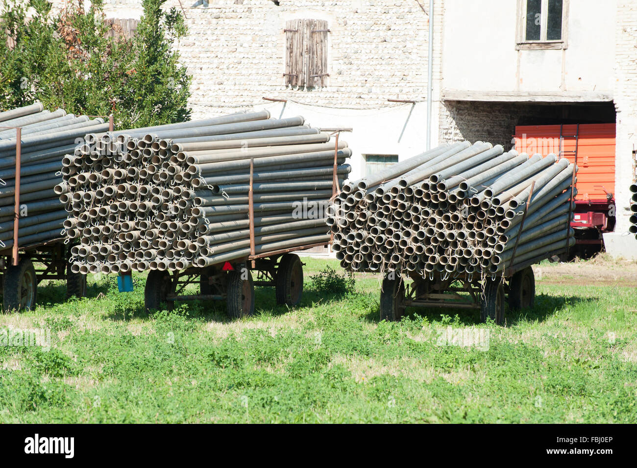 Farm wagons loaded with metal rigid pipes for irrigation Stock Photo ...