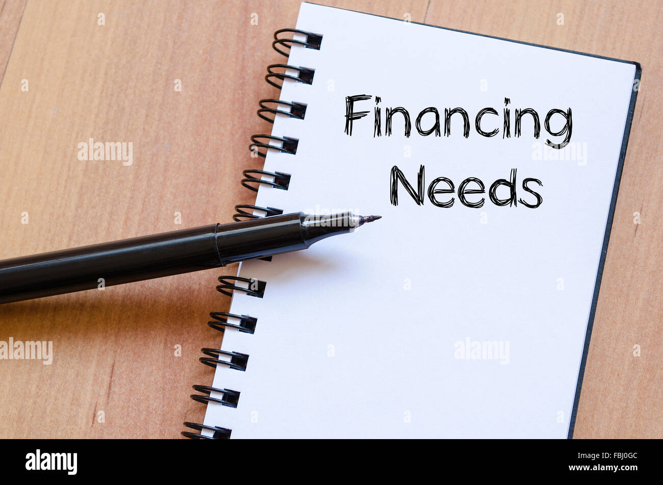 Financing needs text concept write on notebook with pen Stock Photo - Alamy