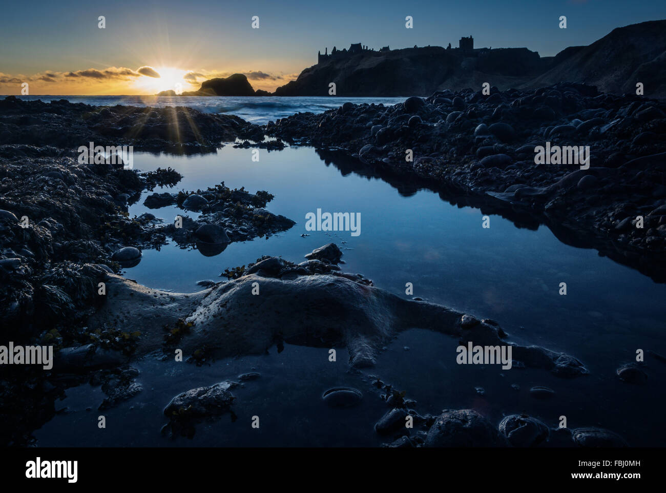 Dawn on the winter solstice near Dunnottar Castle, Stonehaven, Scotland ...