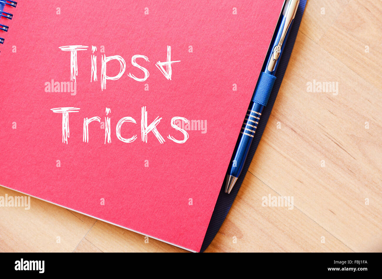 Tips and tricks text concept write on notebook with pen Stock Photo - Alamy
