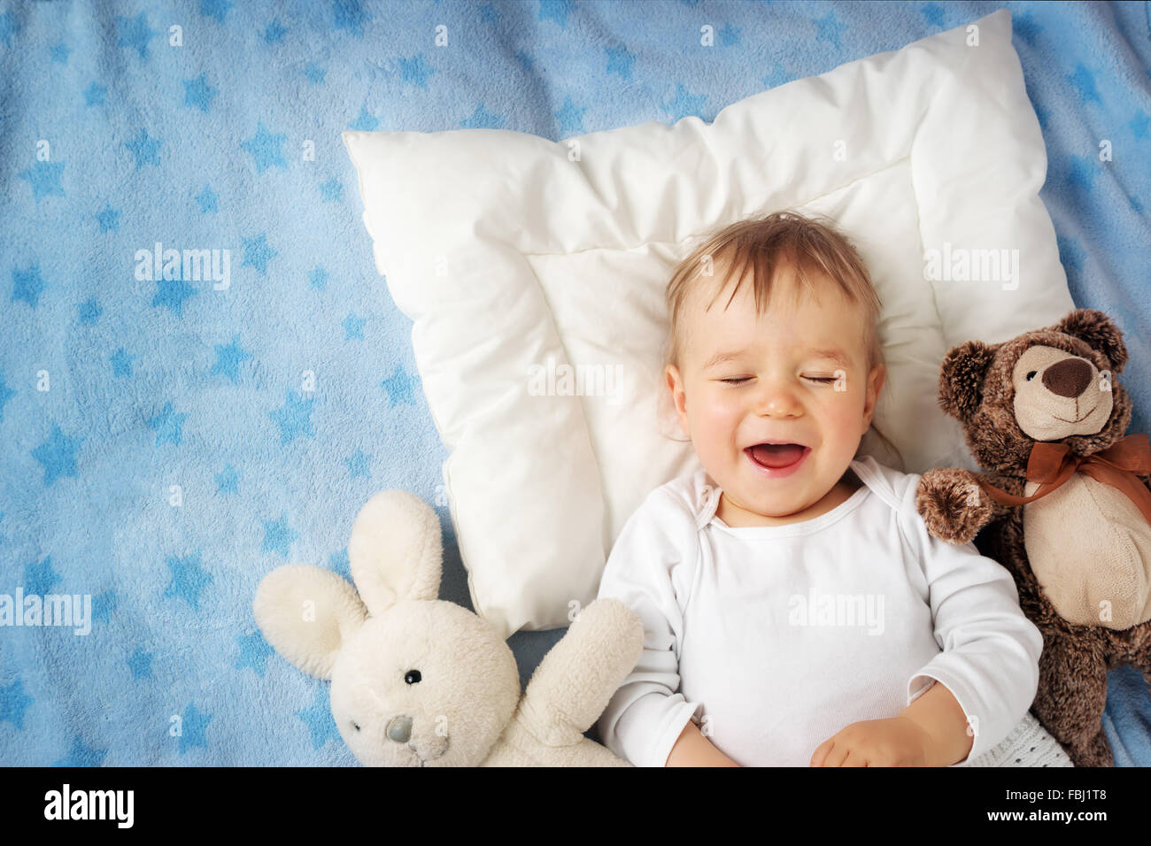 One year old baby with alarm clock Stock Photo - Alamy