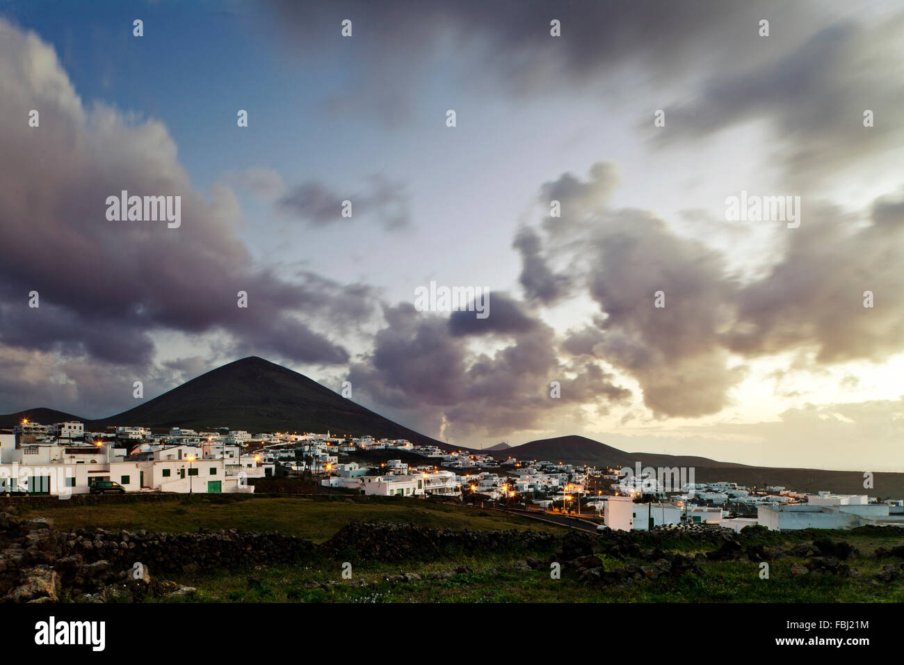 Volcano village at sunrise Stock Photo - Alamy
