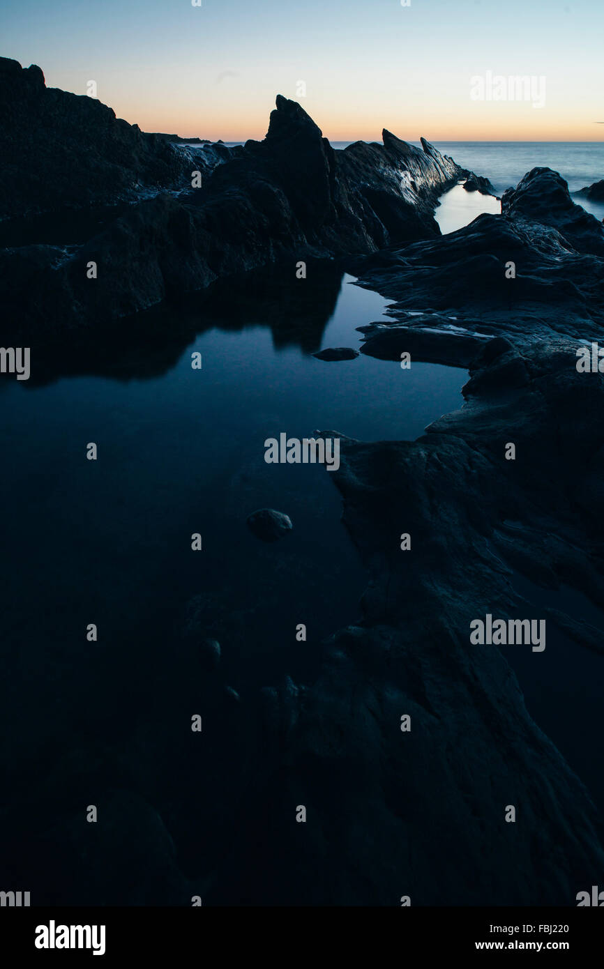 Water between rocks on the beach Stock Photo - Alamy