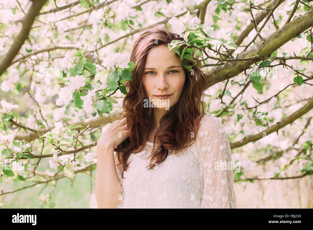 young woman under tree Stock Photo - Alamy