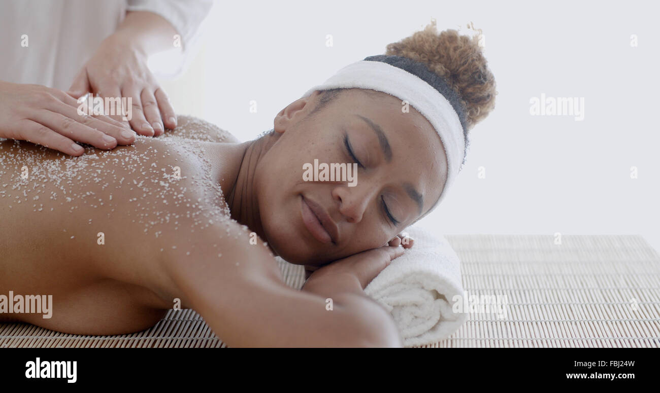 Female Getting A Salt Scrub Treatment Stock Photo - Alamy