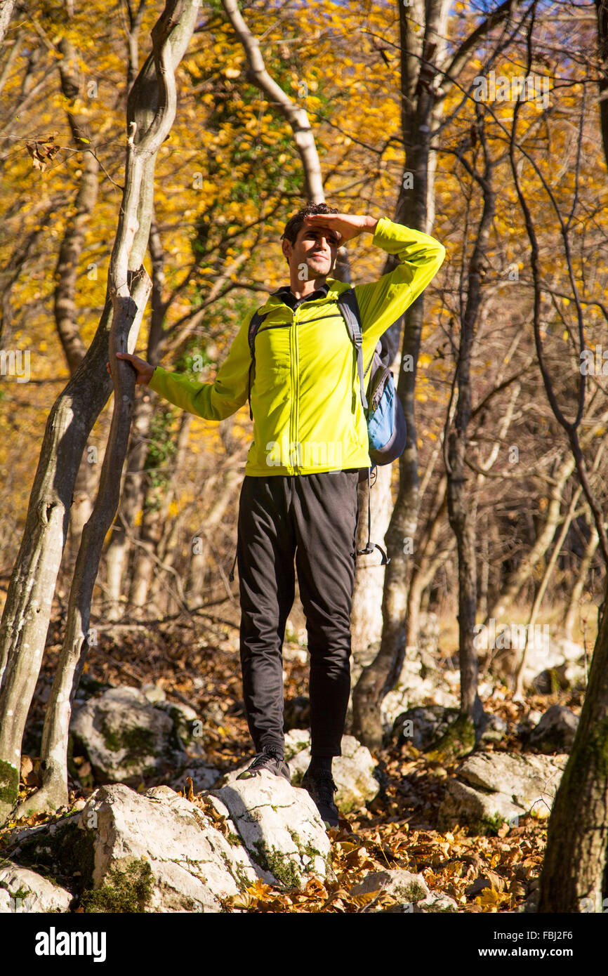 Young man hiking in the forest Stock Photo - Alamy