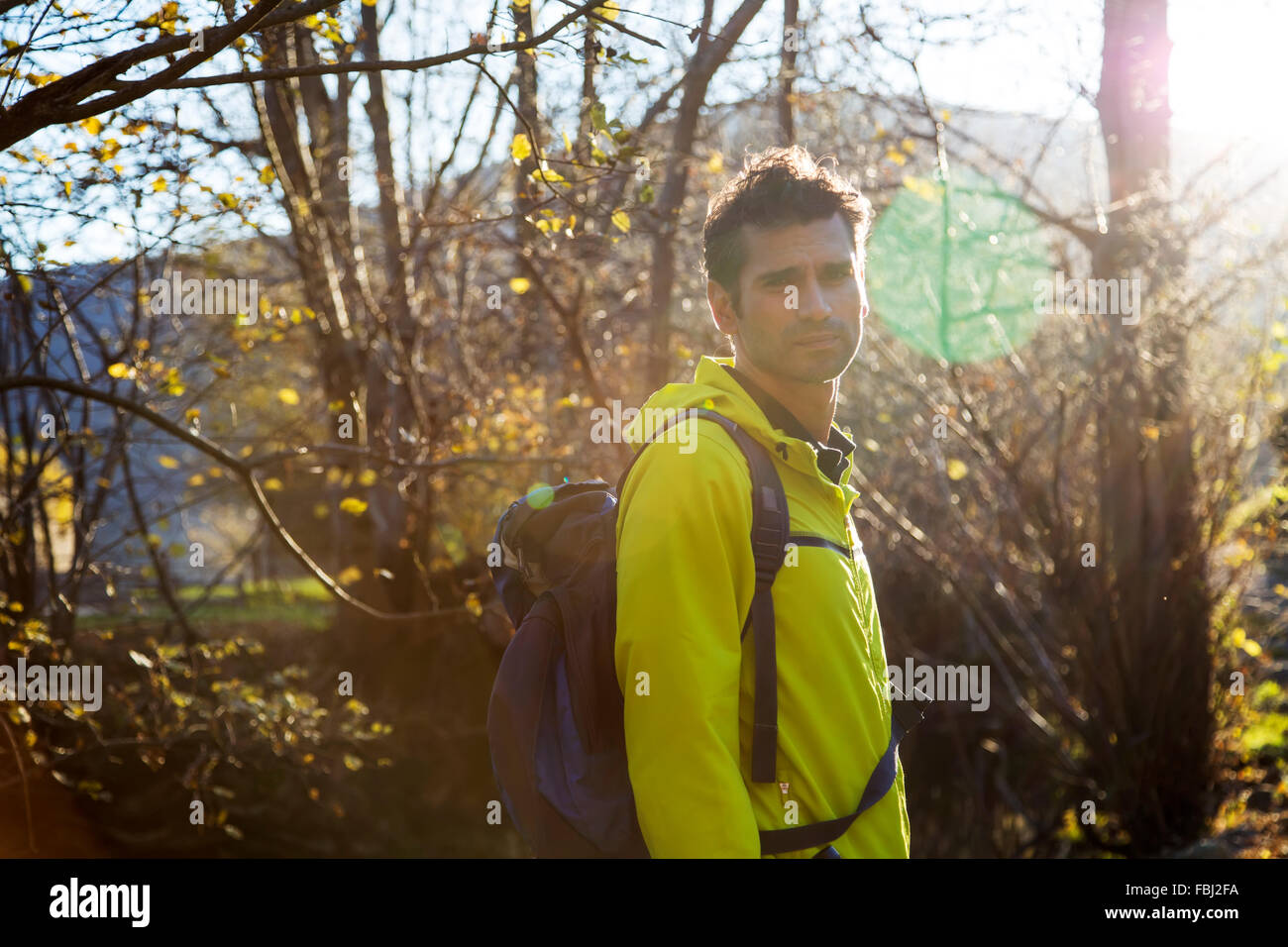 Young man hiking in the forest Stock Photo - Alamy
