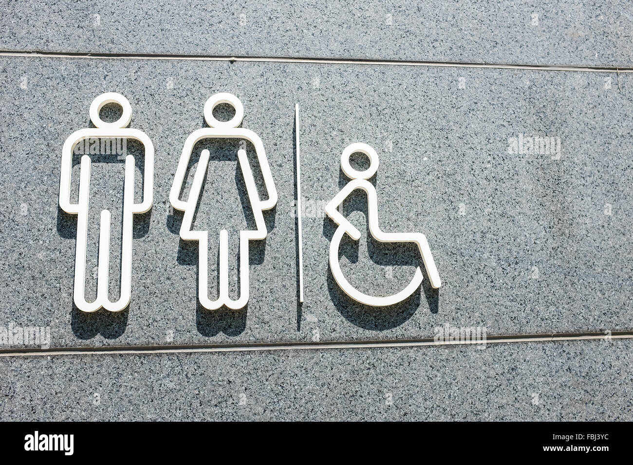 Restroom symbol on mable wall Stock Photo - Alamy