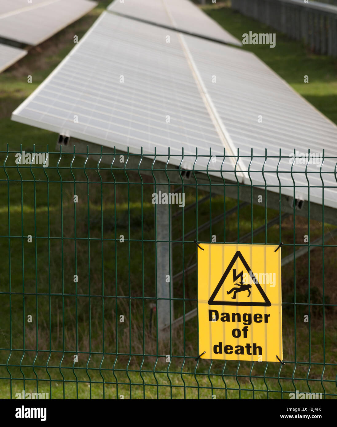 Warning sign of "danger of Death" on the fence of a solar panel farm ...