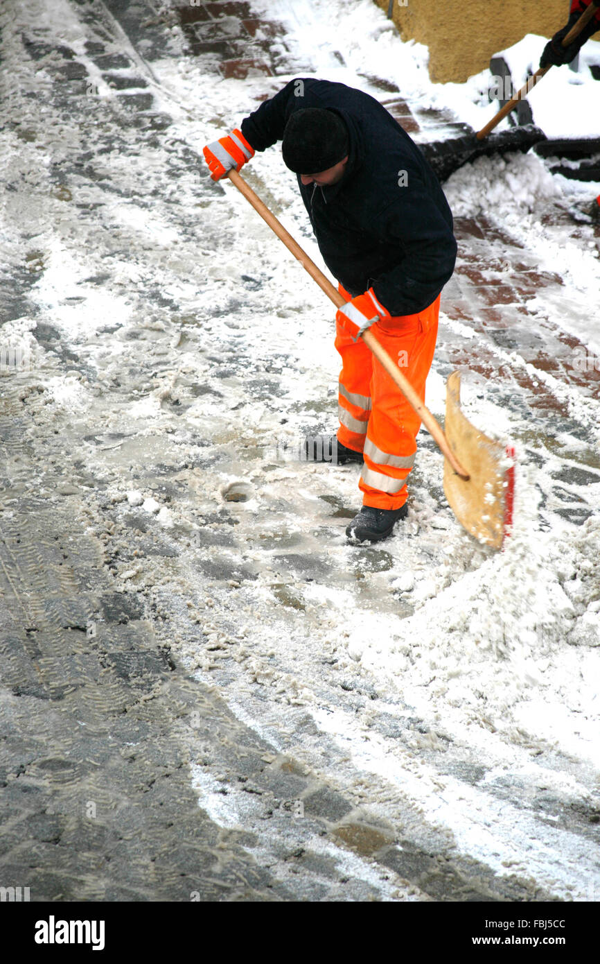 Man, winter, snow ploughing service Stock Photo - Alamy