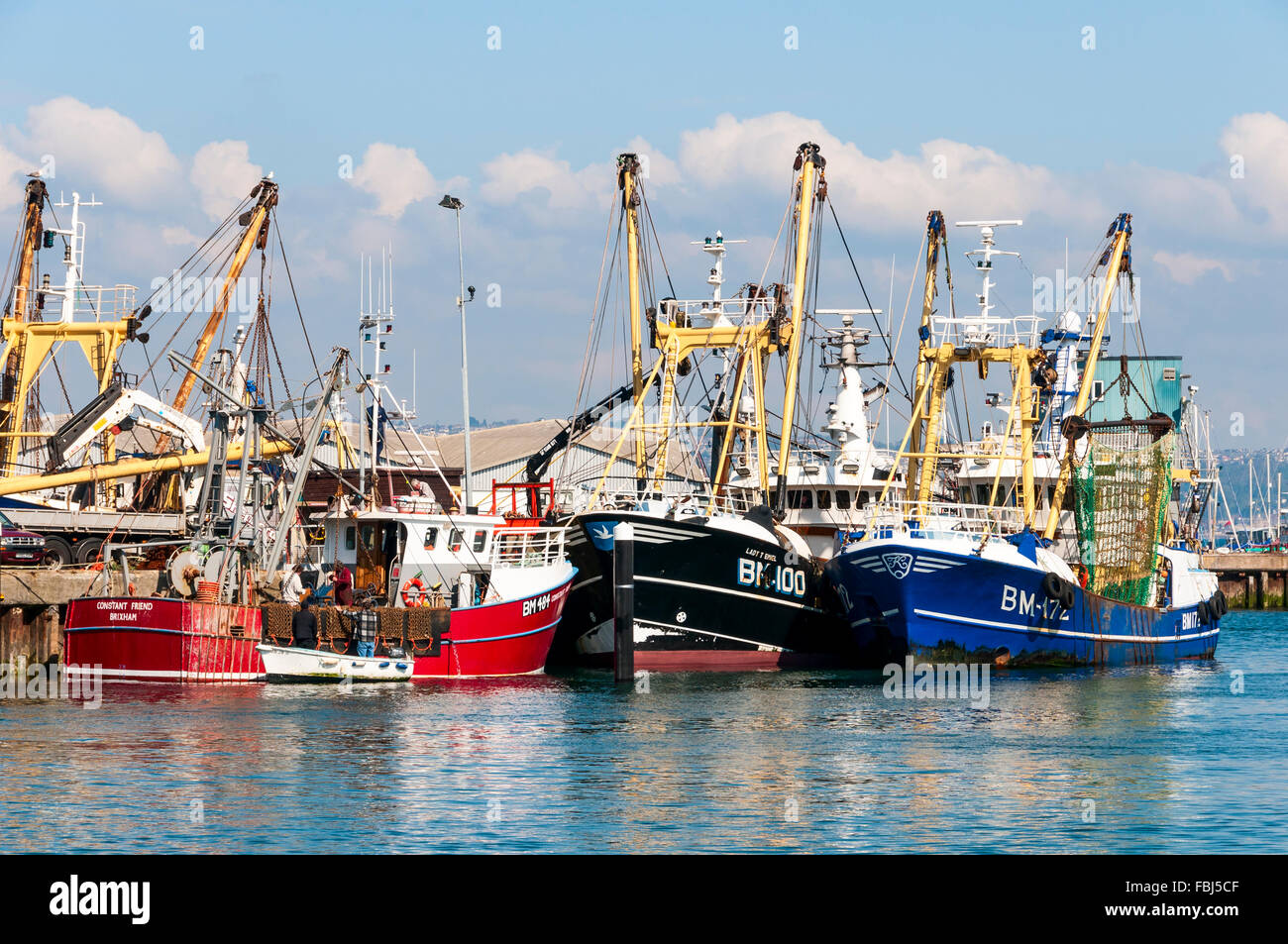 The crew of the red painted trawler Constant Friend are overlooked by ...