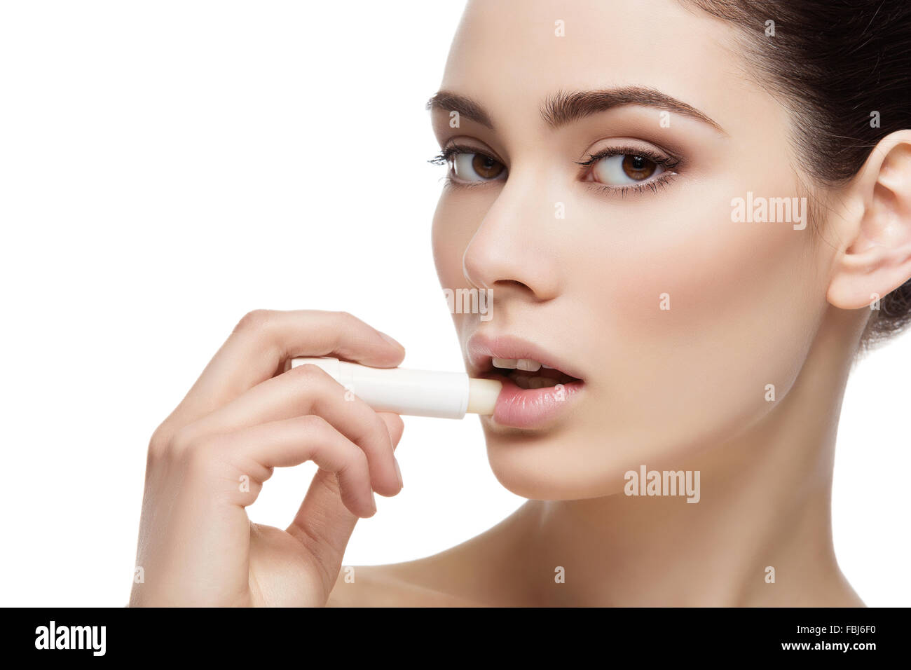Beautiful girl applying chapstick Stock Photo - Alamy