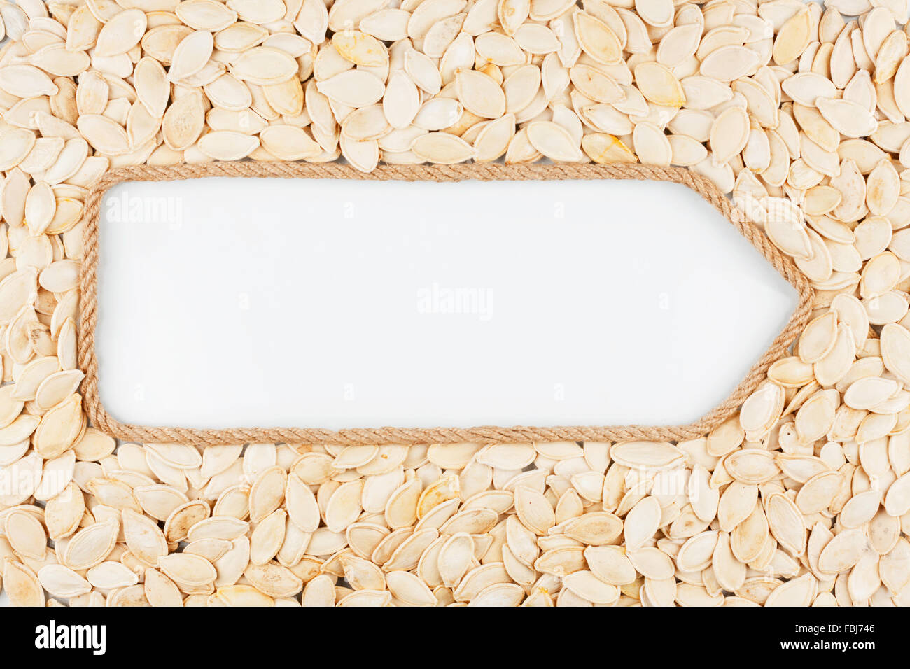 Pointer made from rope with seeds pumpkin lying on a white background ...