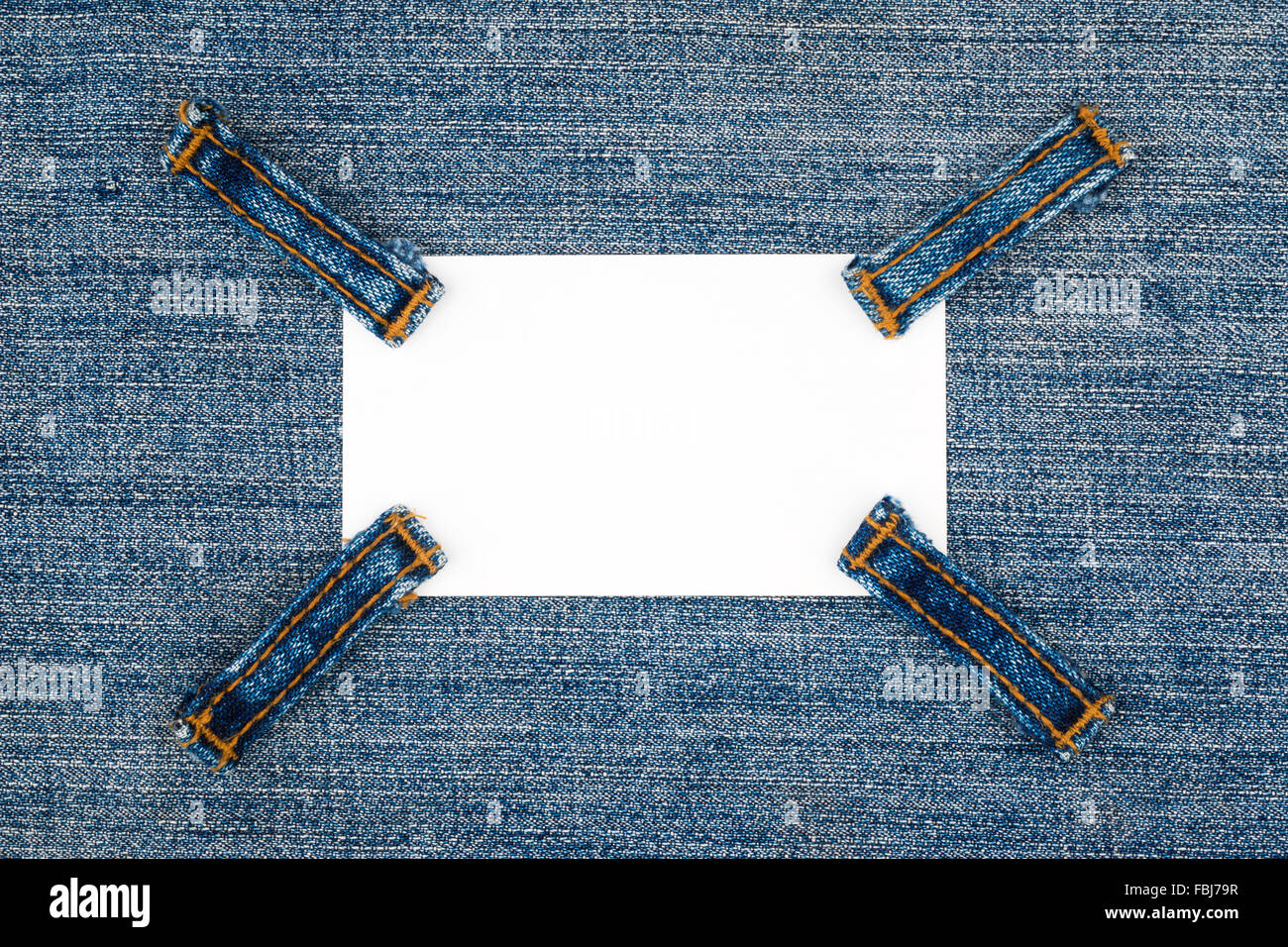 Business card with four straps jeans, lies on the light denim, with ...